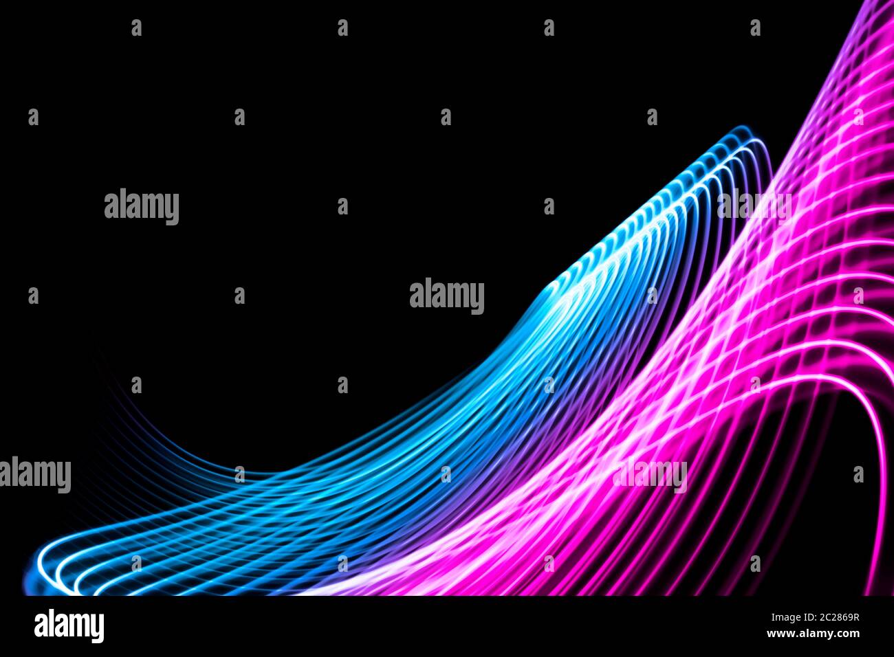 Abstract rainbow neon glowing crossing lines pattern. Dark background of colorful neon glowing ...