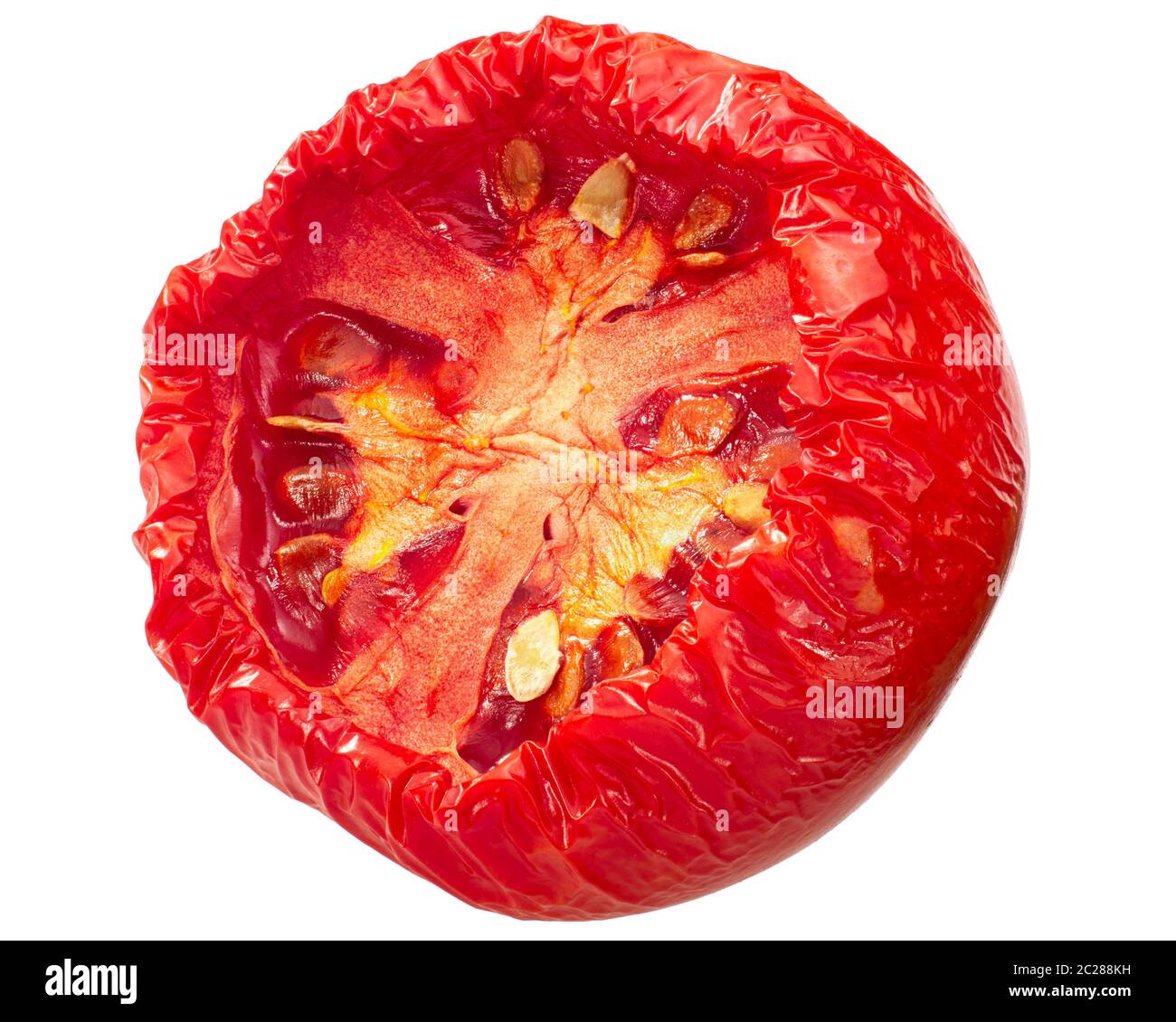 Semi-dried globe tomato half, isolated Stock Photo - Alamy