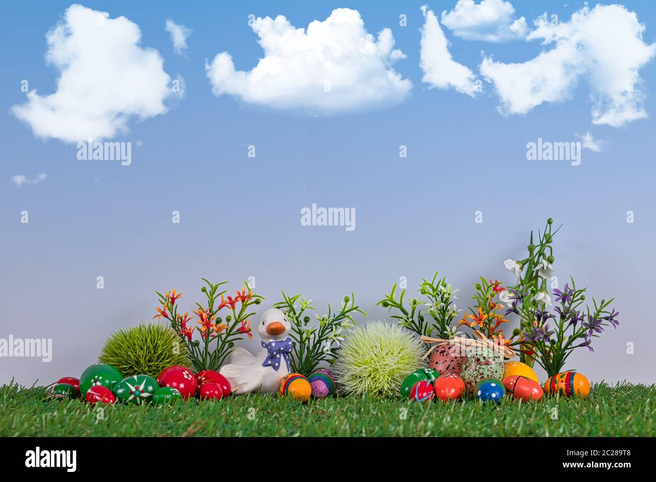 The goose with the colorful Easter eggs Stock Photo - Alamy
