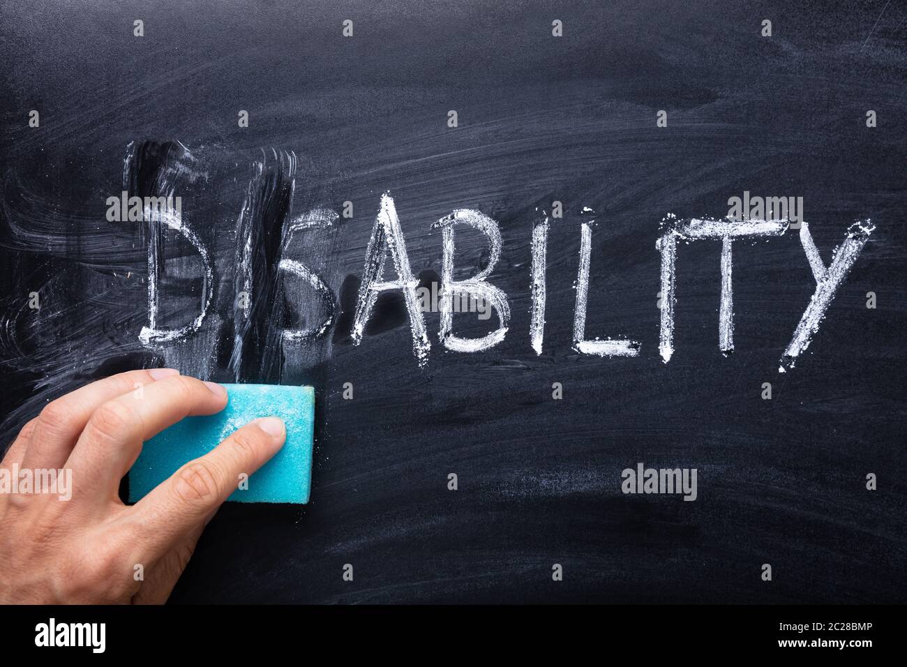 Man's Hand Erasing Dis Text From Disability Word With Sponge Over ...