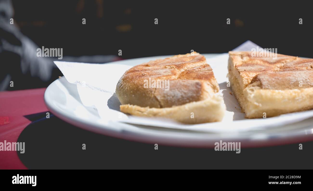 Toast of toasted bread placed on a plate at the terrace of a Portuguese ...