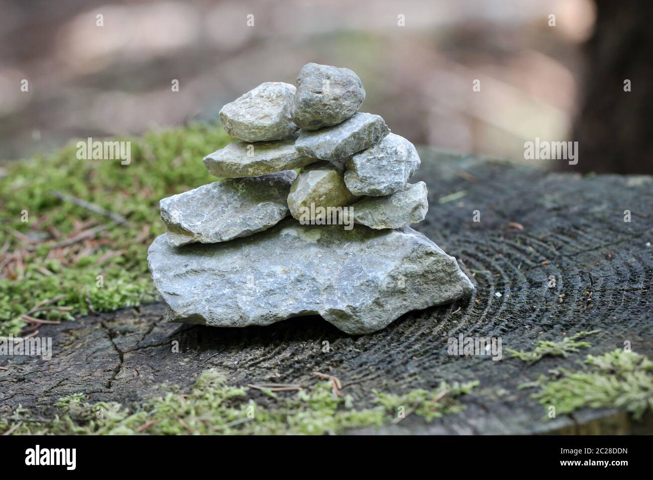 Stones as a pyramid stacked on a tree stump Stock Photo - Alamy