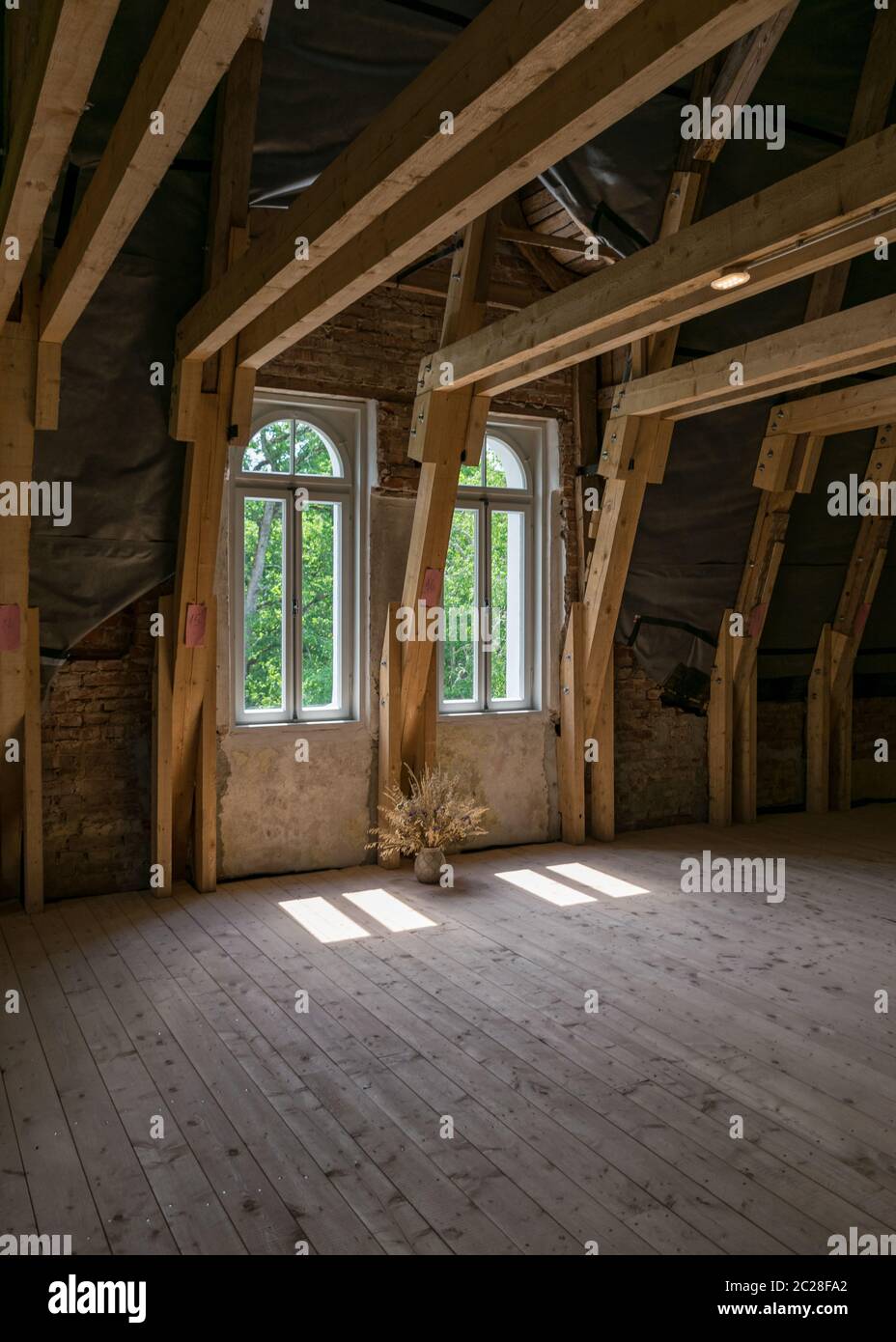 picture with wooden beams and windows in the roof attic, view out the ...