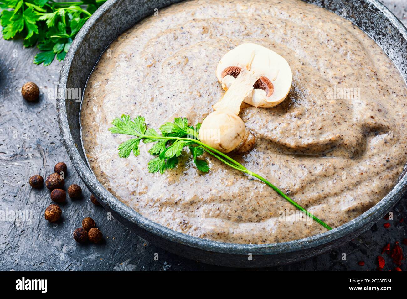 Delicious soup puree with champignons and fresh mushrooms on rustic ...