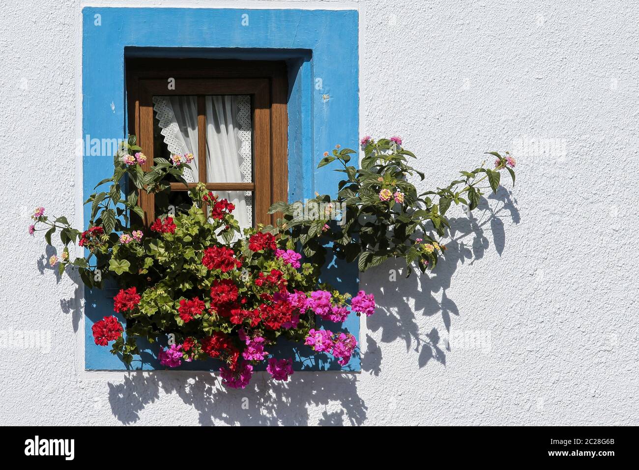 Small window with flower decoration Stock Photo - Alamy