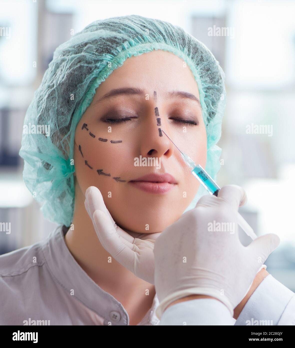 Plastic surgeon preparing for operation on woman face Stock Photo - Alamy