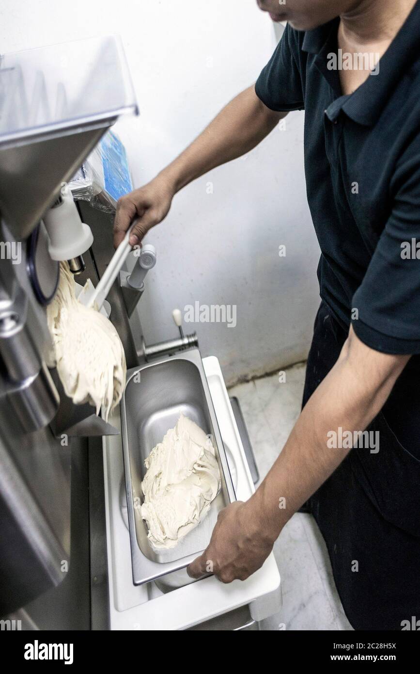 making gelato ice cream with modern professional equipment preparation ...