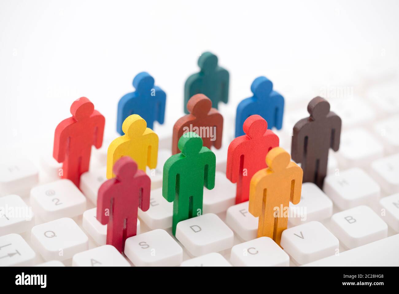 Colorful painted group of people figures on computer keyboard Stock ...