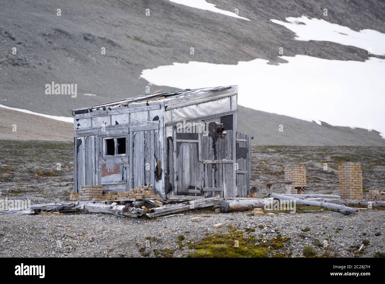 Abandoned wooden cabin in the tundra of Spitsbergen. Drift wood and ...