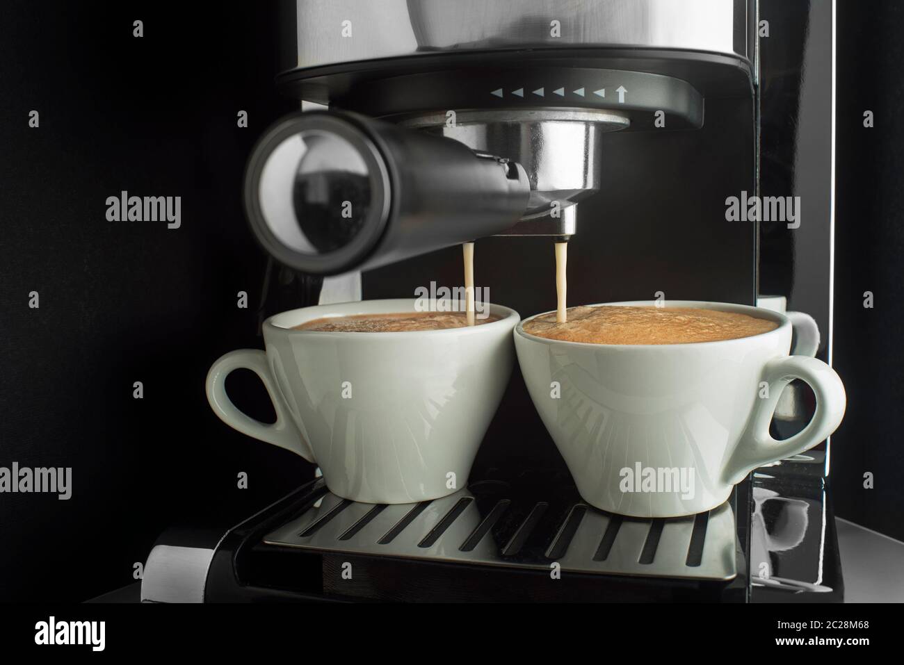 Espresso coffee pouring from coffee machine. Professional coffee ...