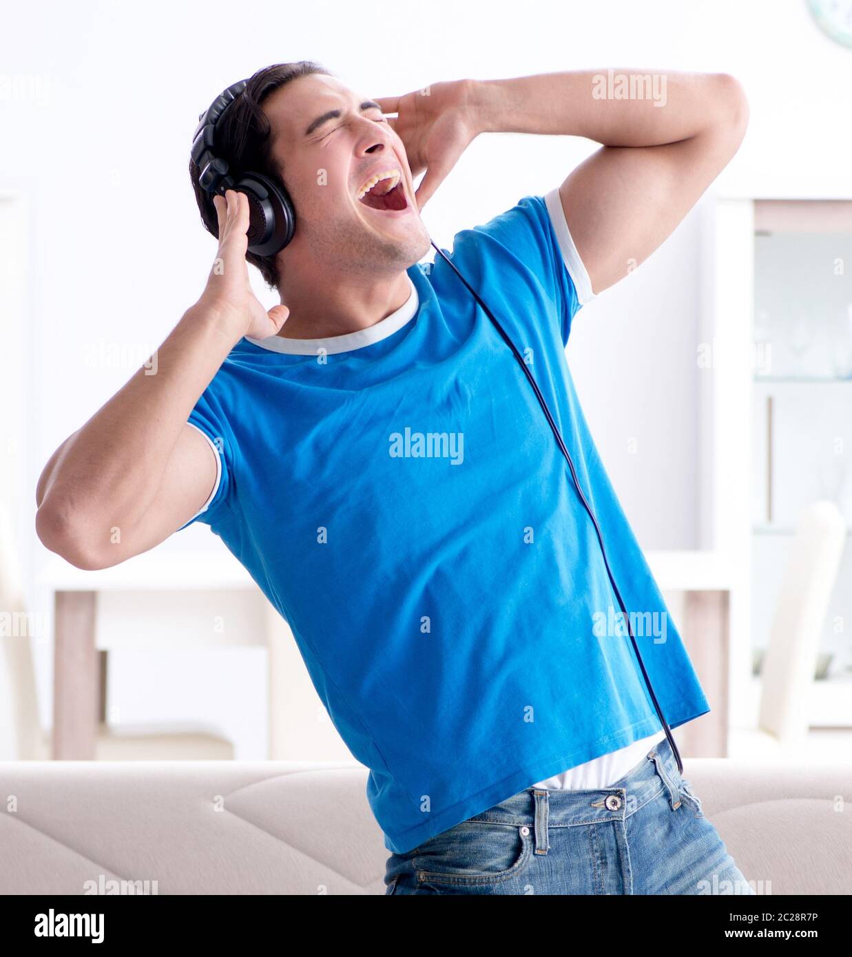 Young man singing at home karaoke Stock Photo - Alamy