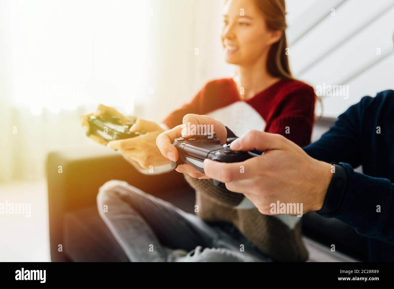 Close-up view of game controllers. Young beautiful girl playing ...