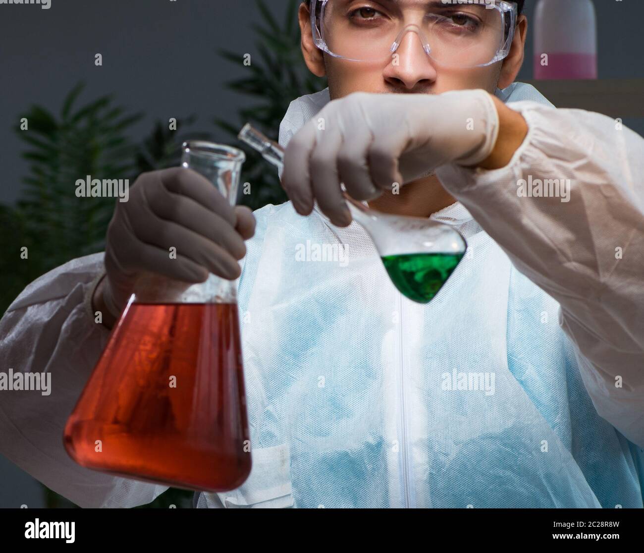 Young male lab chemist late at night in overtime time Stock Photo - Alamy