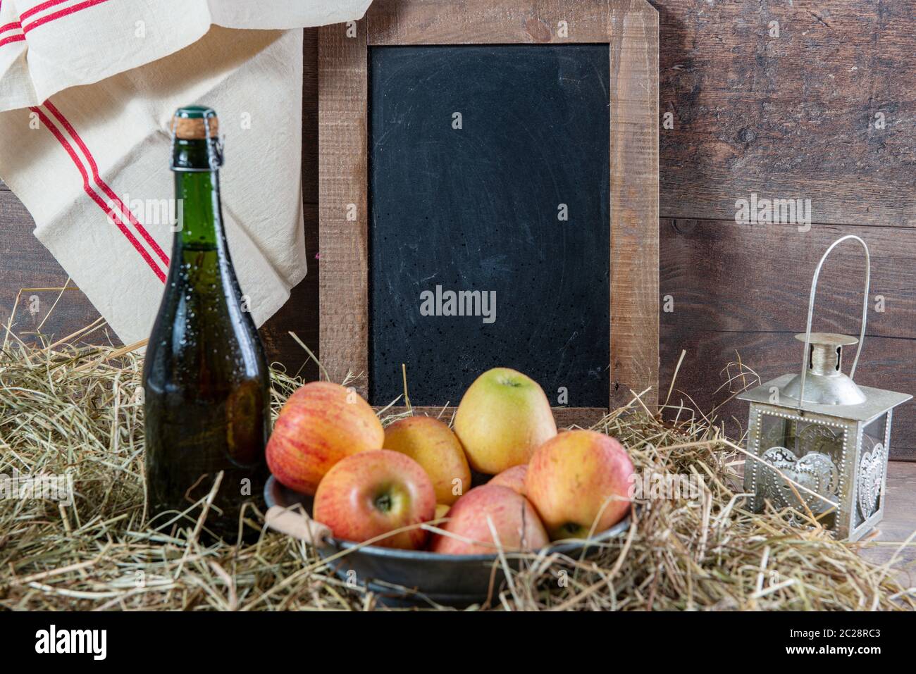 Bottle of cider with apples on the straw, and a school chalkboard Stock ...
