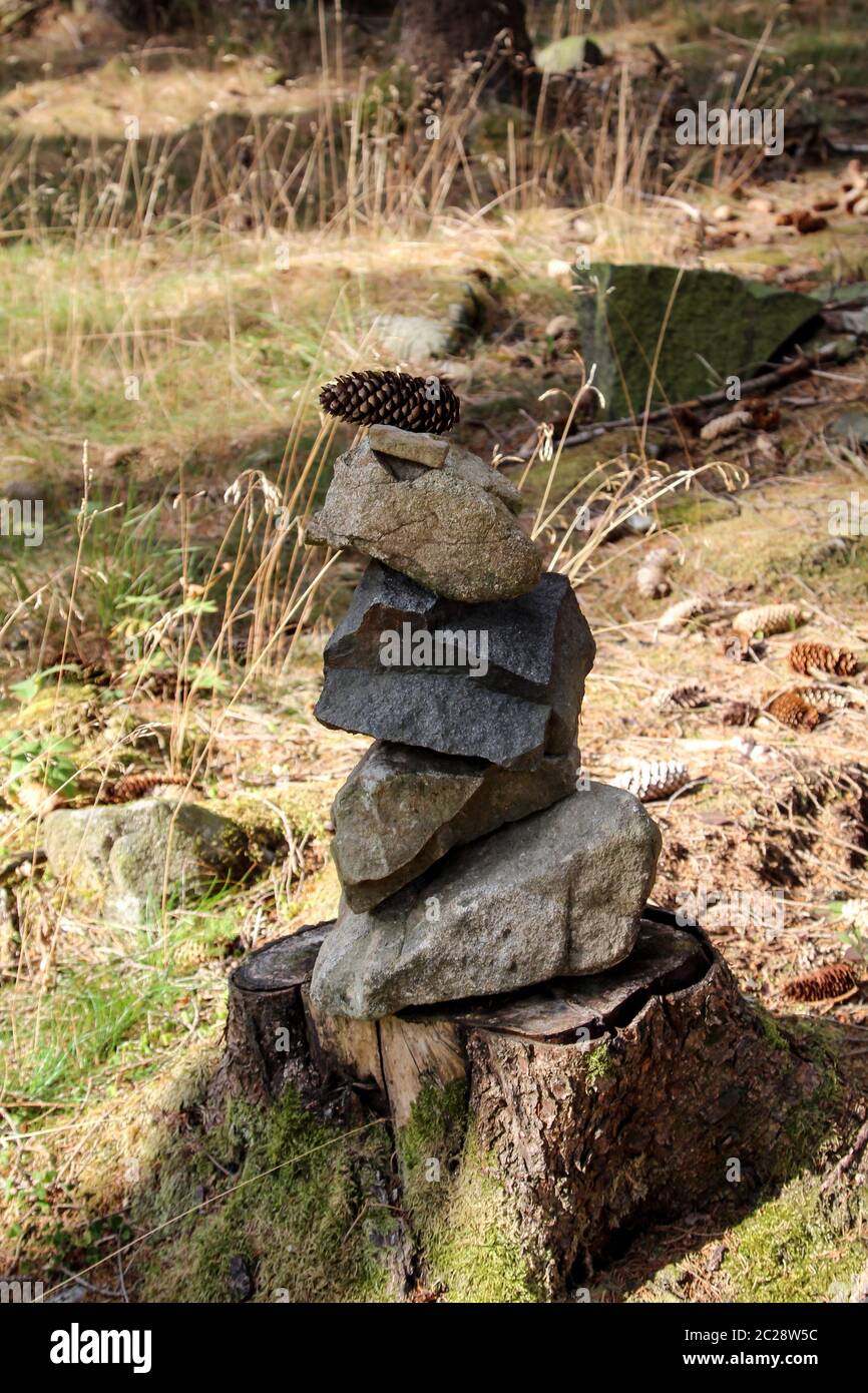 Stones as a pyramid stacked on a tree stump Stock Photo - Alamy