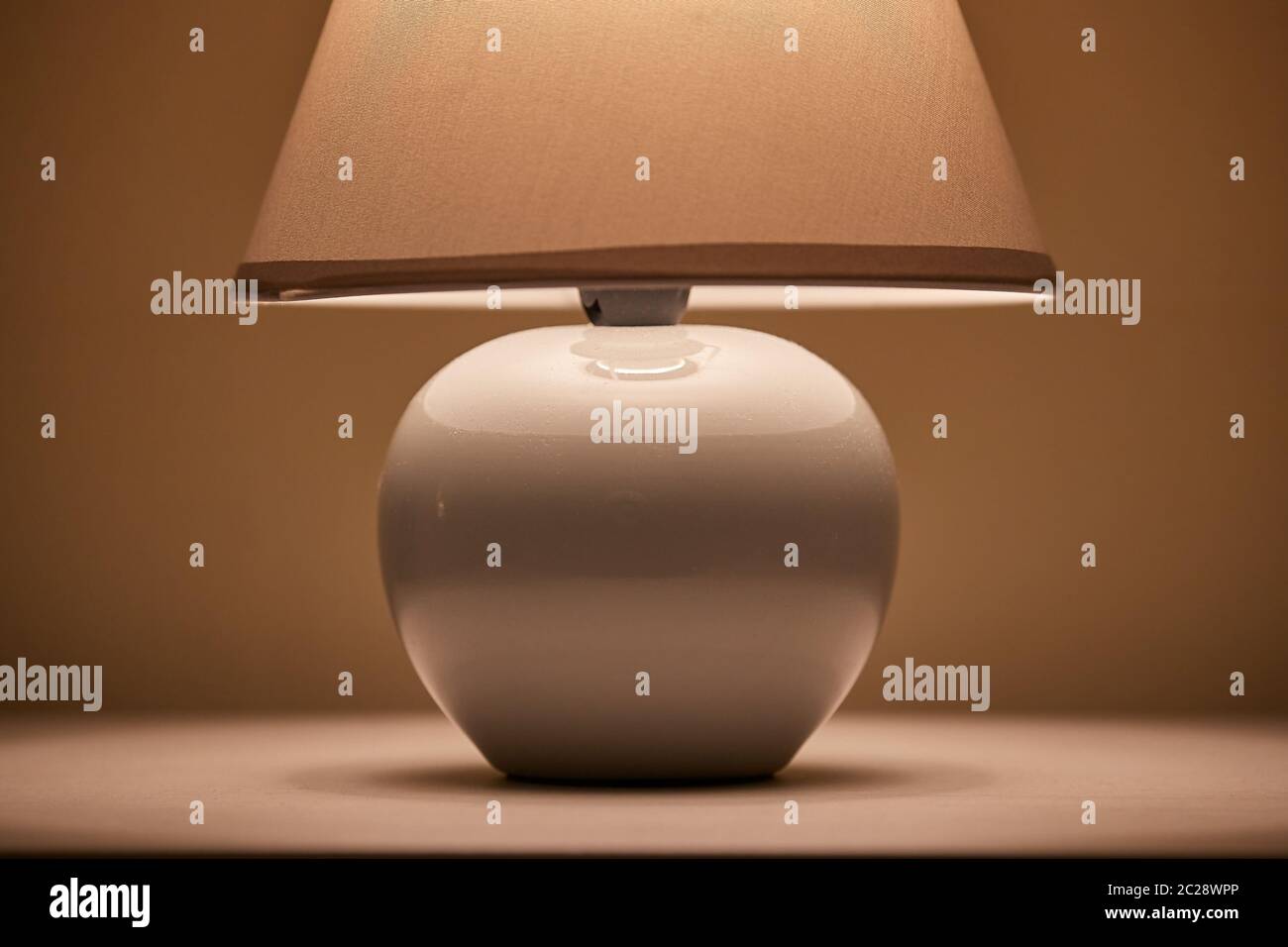 Small lamp glowing in bedroom, close up Stock Photo - Alamy