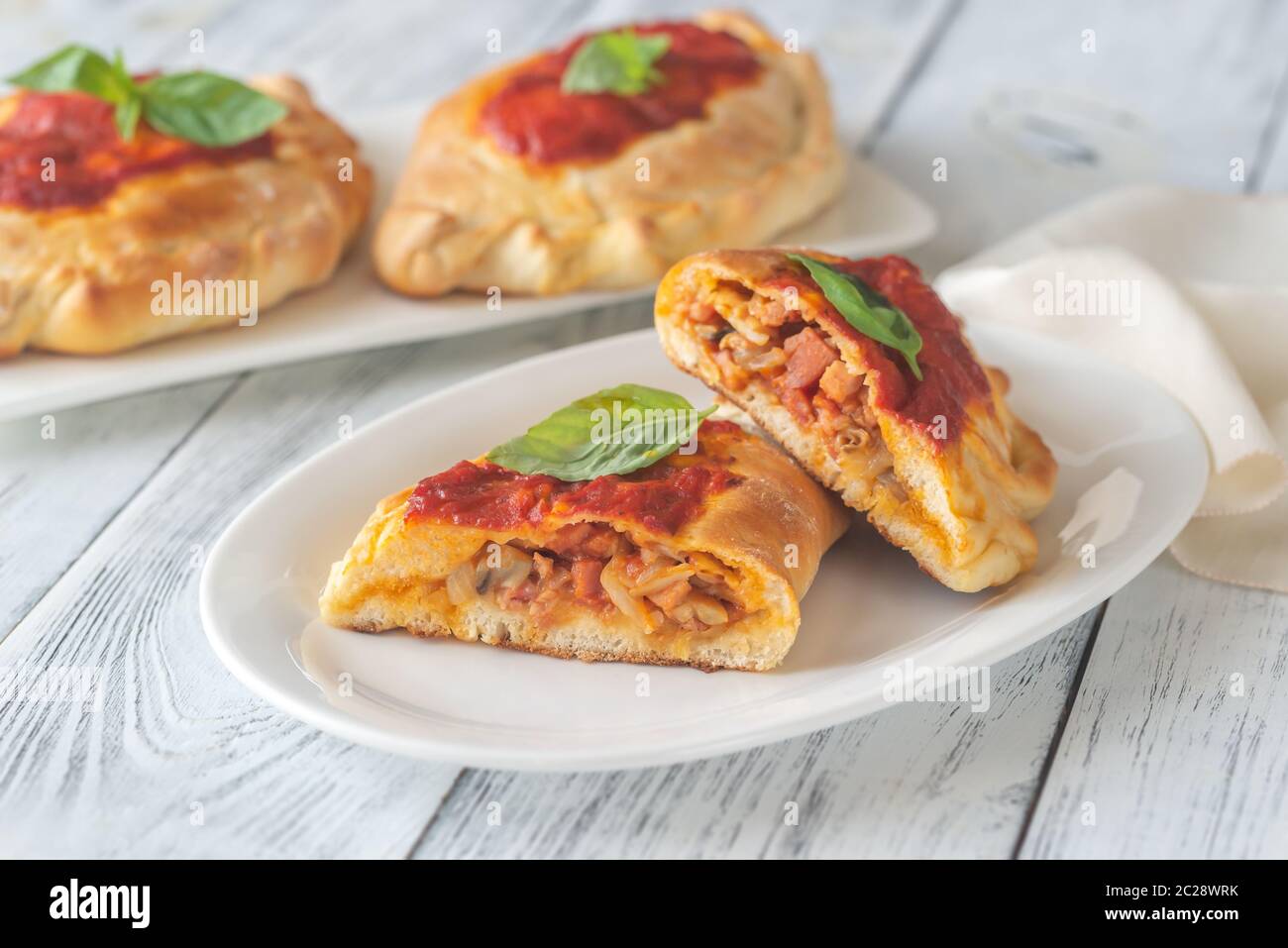 Homemade calzone stuffed with pancetta and mushrooms: cross section ...