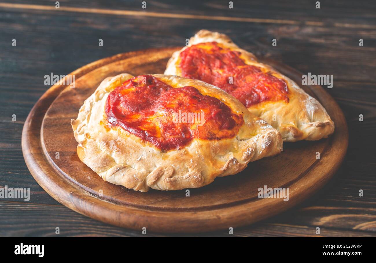 Homemade calzone stuffed with pancetta and mushrooms: cross section ...