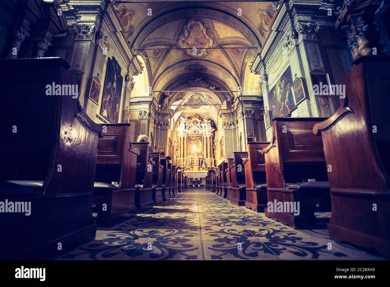 Historic catholic church: Wooden pews in a row and altar width crucifix ...