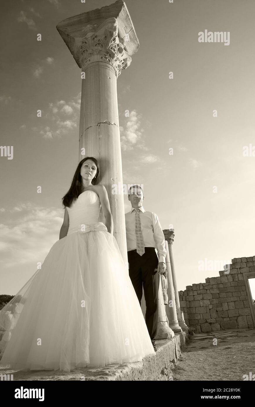 Beautiful wedding couple- bride and groom near greece column in the ...