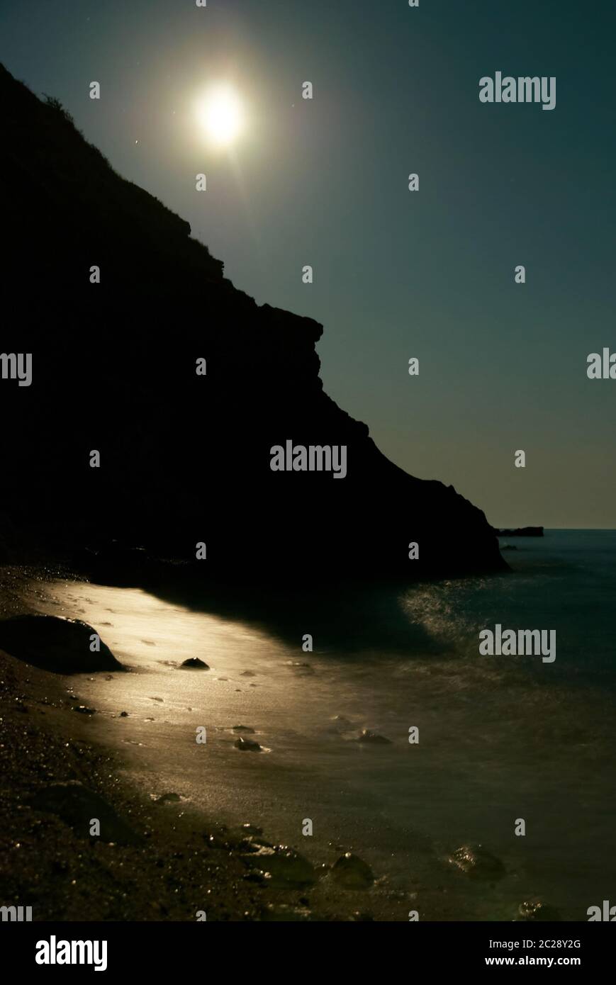 Moon night on the sea with waves and rocks Stock Photo - Alamy