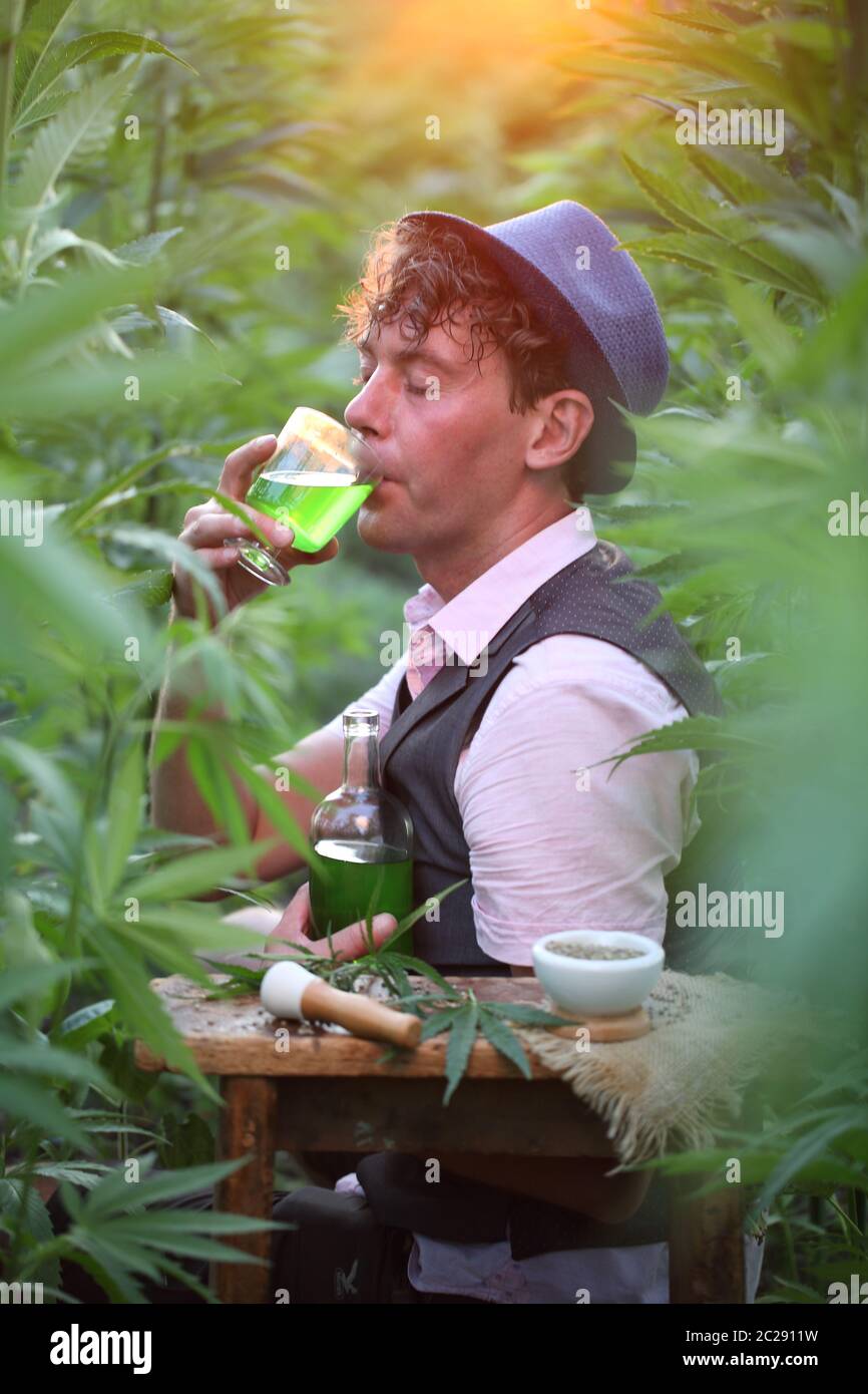 A man pours hemp wine from a bottle Stock Photo - Alamy