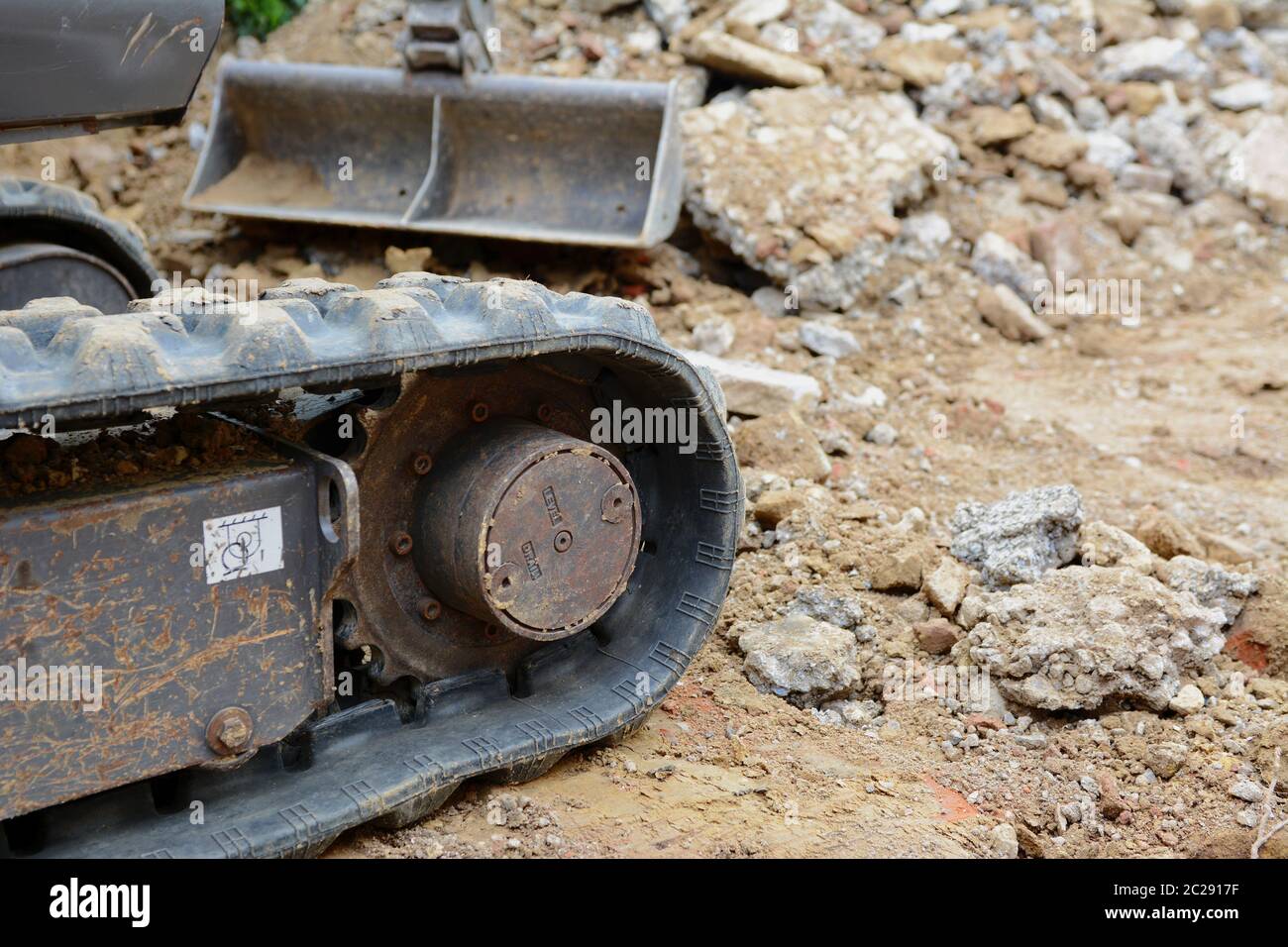 Rubber track of a mini digger in selective focus against background of ...