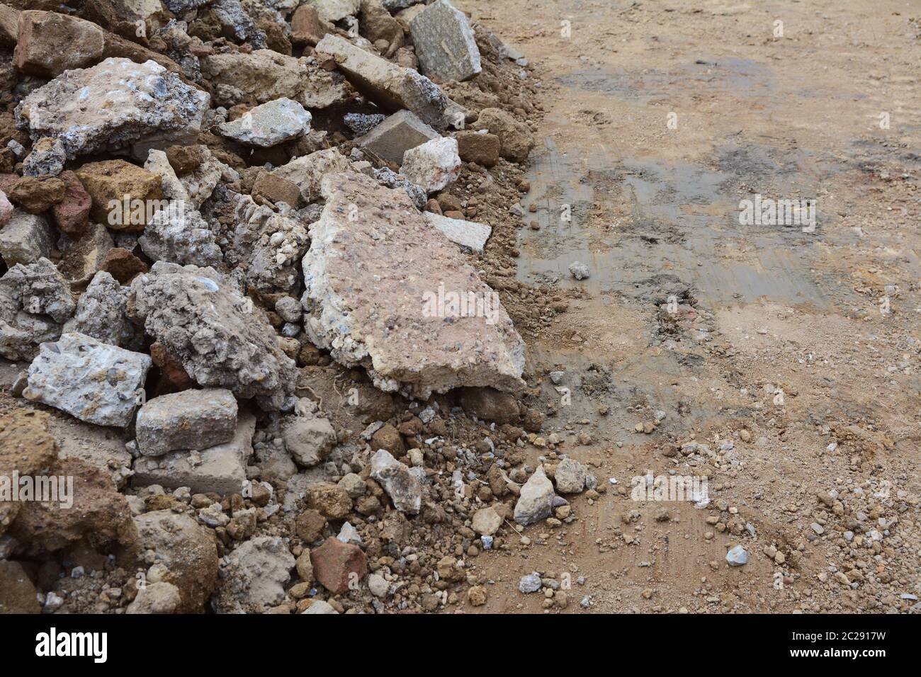 Large broken pieces of rough concrete, bricks and paving slabs next to ...