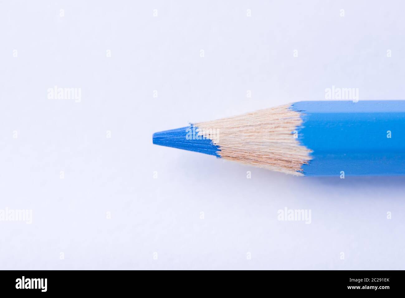Macro photograph of several sharpened pencils of blue color on a white ...