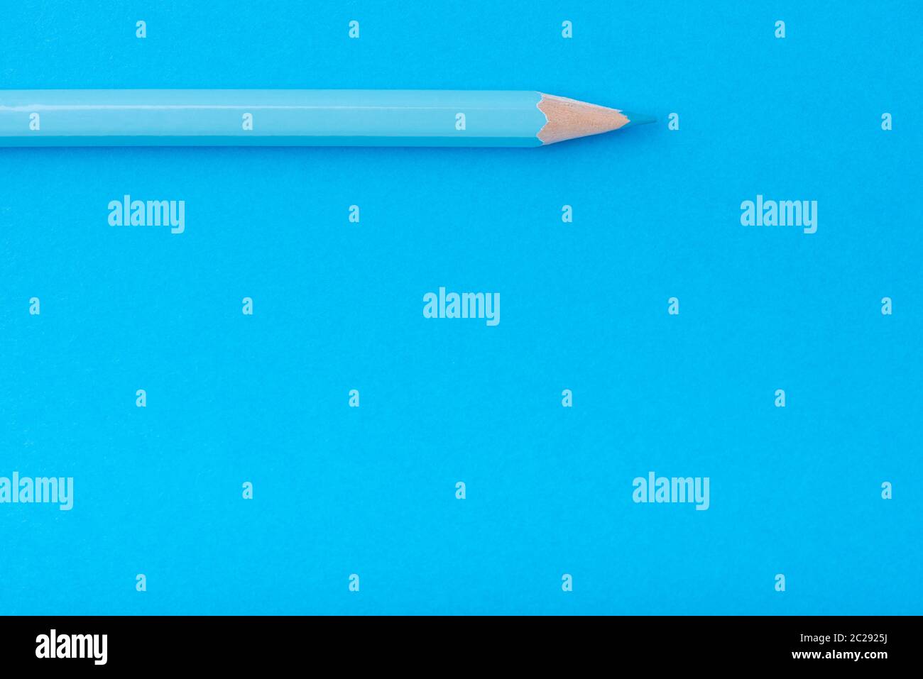 Macro photograph of several sharpened pencils of blue color on a paper ...