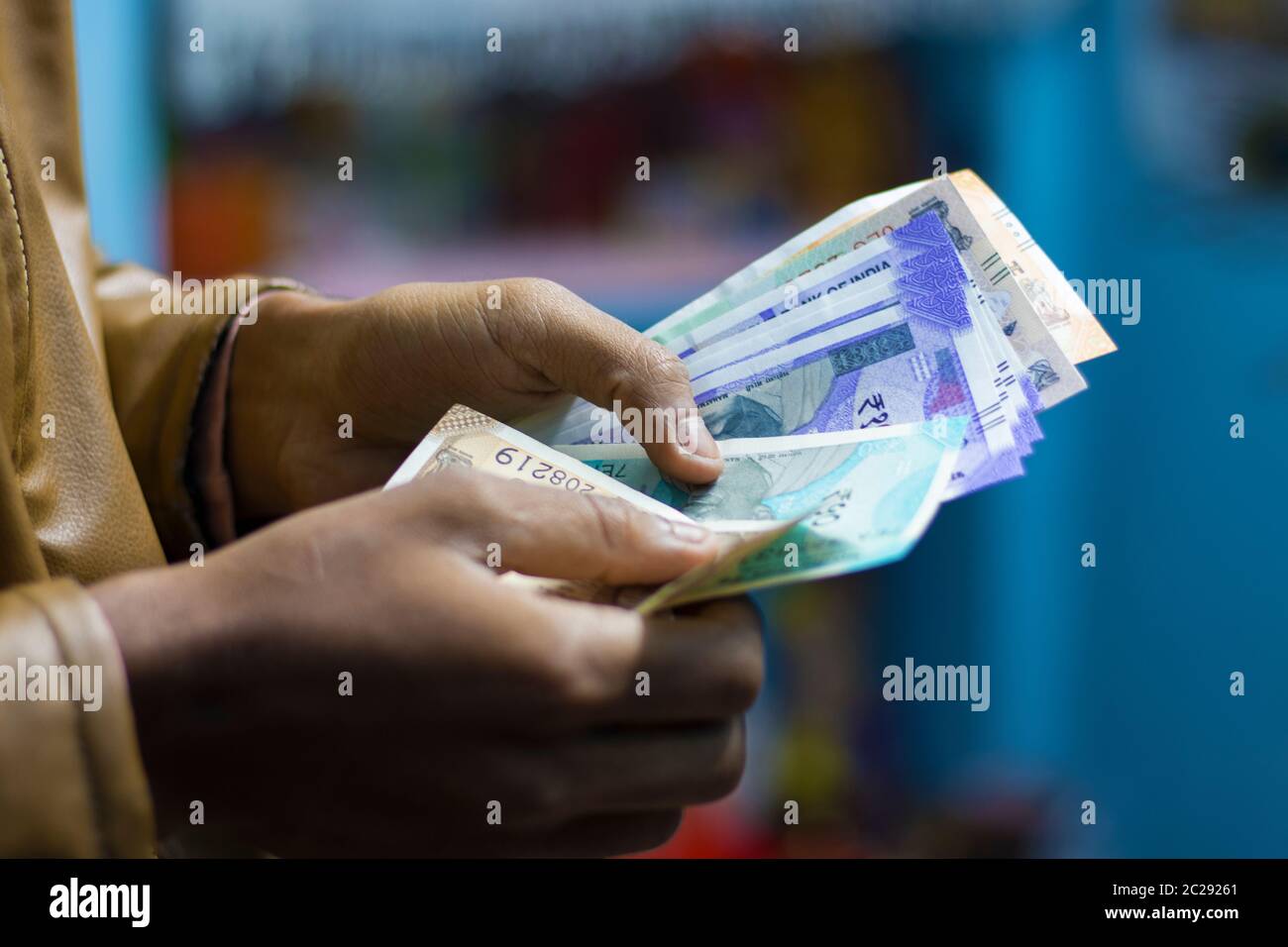 closeup view of a man counting Indian currency Stock Photo - Alamy