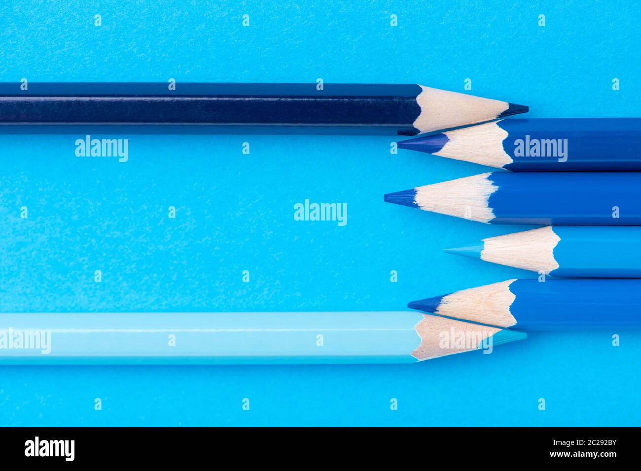 Macro photograph of several sharpened pencils of blue color on a paper ...