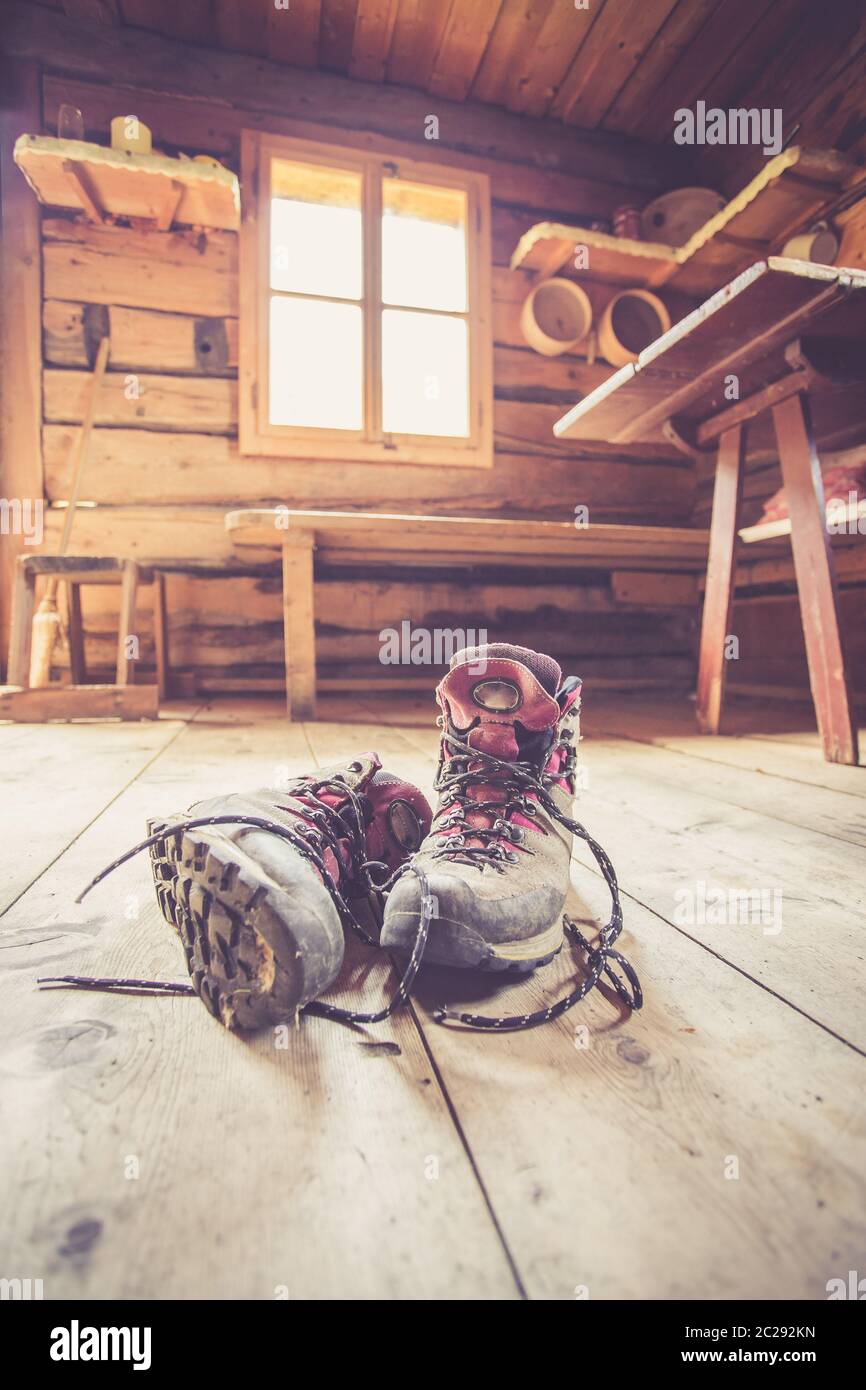 Alpine boots on rustic wood floor in an abandoned mountain chalet in ...