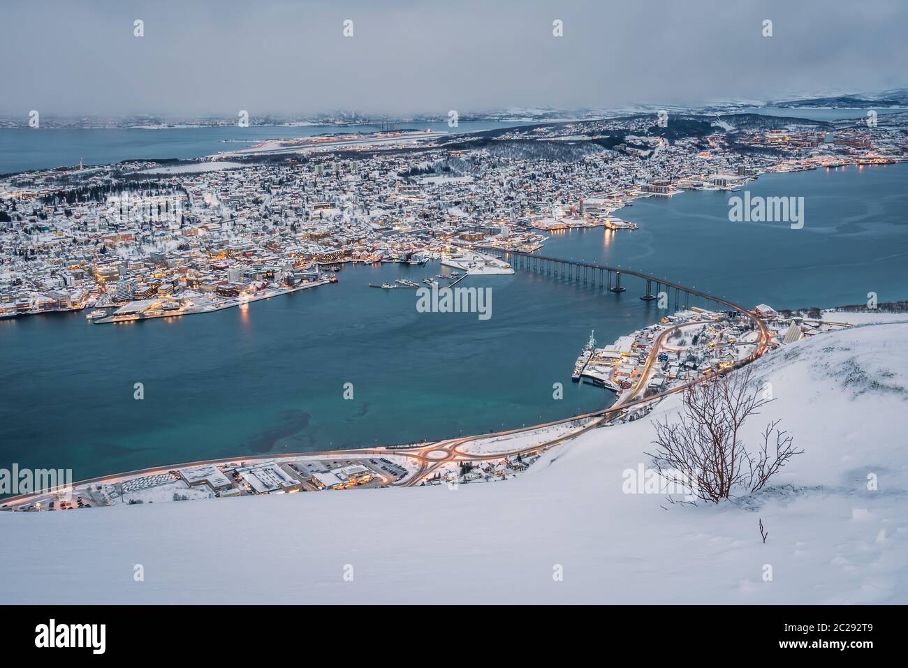 Aerial view to the city of Tromso in winter from the mountain ledge Storsteinen, 421 m above sea ...