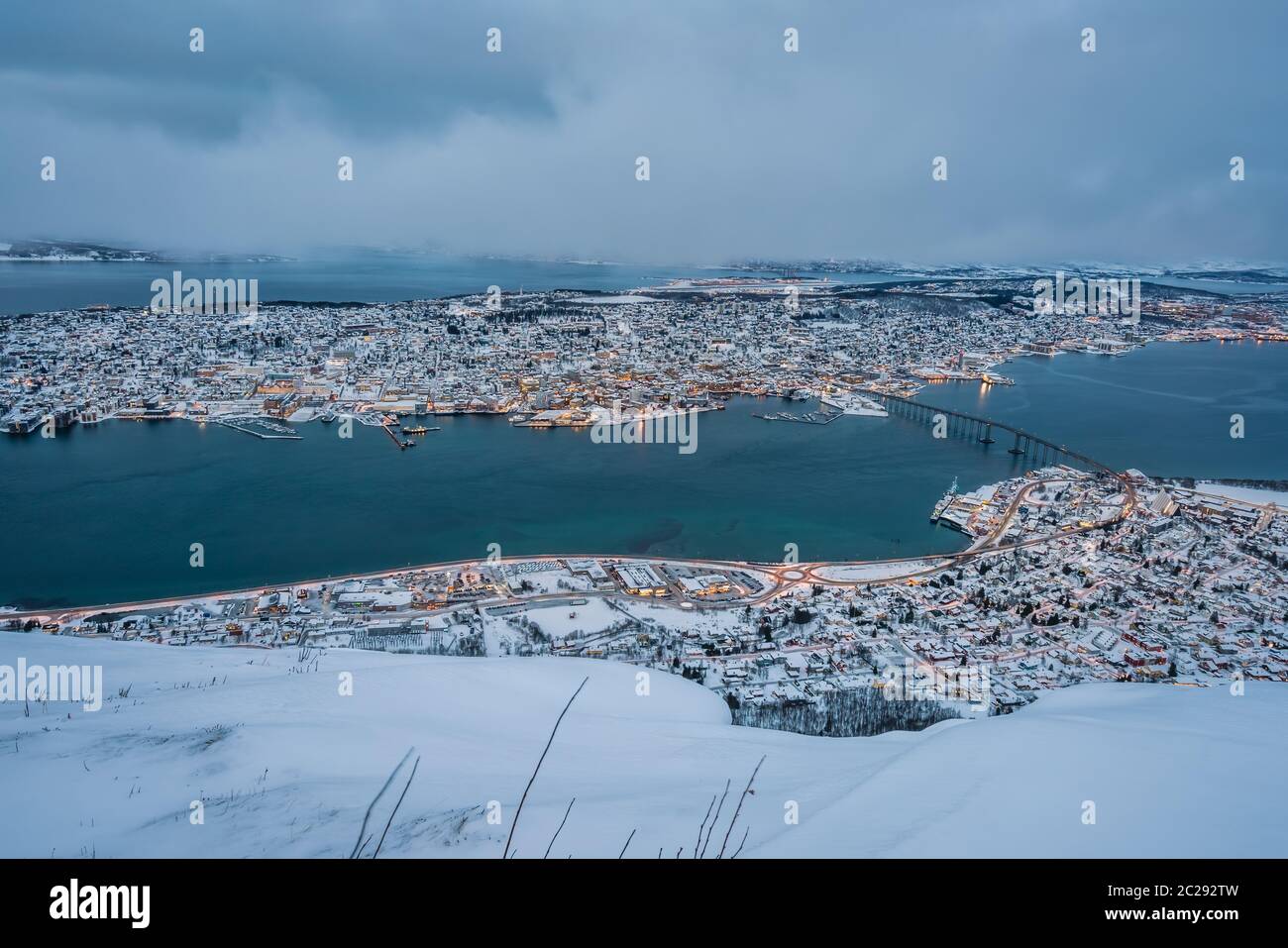 Aerial view to the city of Tromso in winter from the mountain ledge Storsteinen, 421 m above sea ...