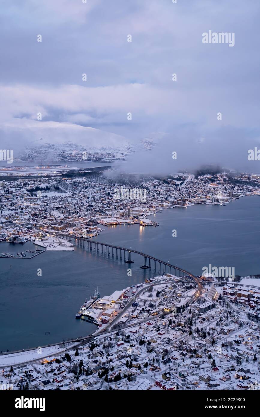 Aerial view to the city of Tromso in winter from the mountain ledge ...