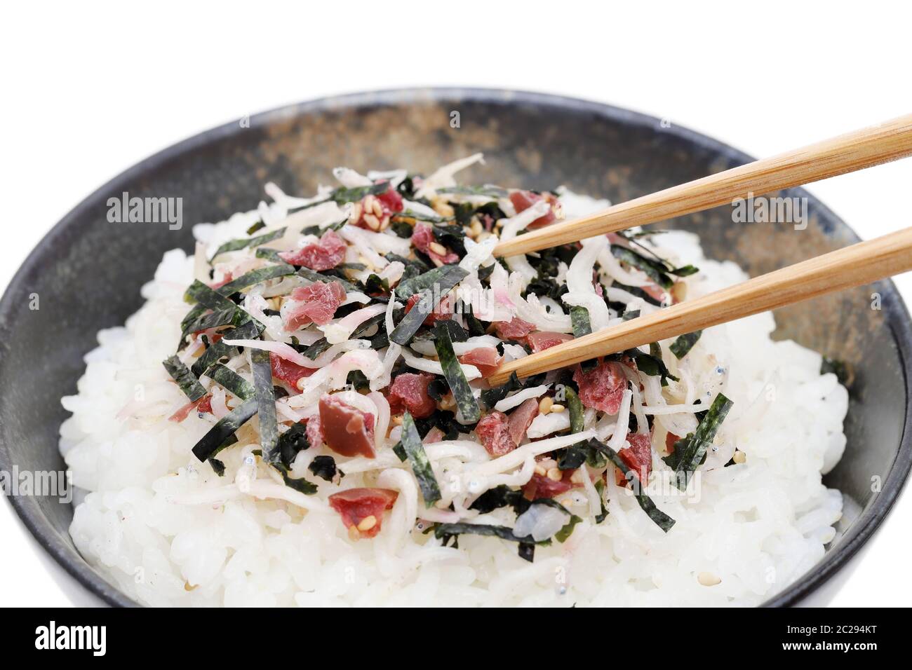 Japanese Shirasu and umeboshi on cooked white rice on white background ...