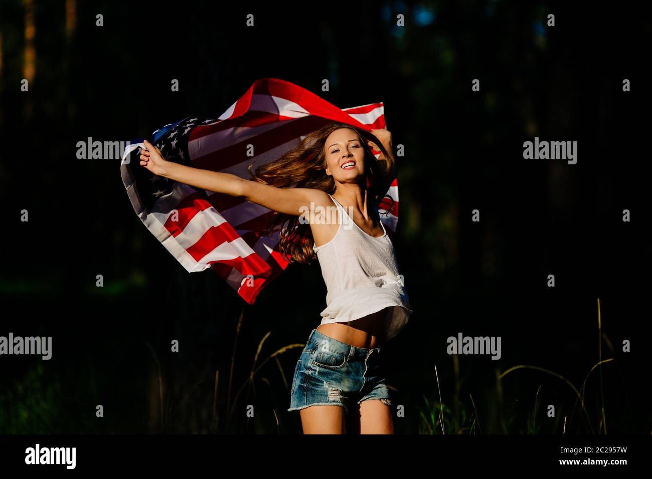 Girl jumping with flag hi-res stock photography and images - Alamy