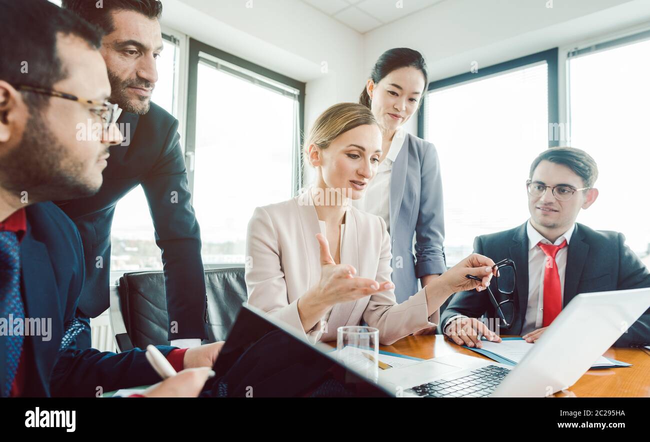 International business team working together looking at the numbers ...