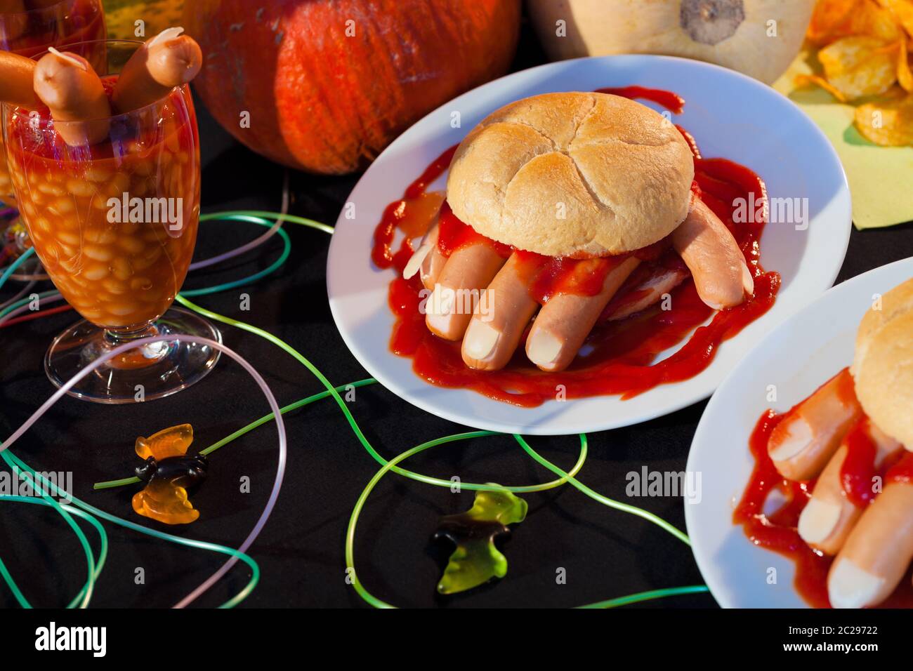 Hot dog in shape of human hand kept in burger with sausage as blood for ...