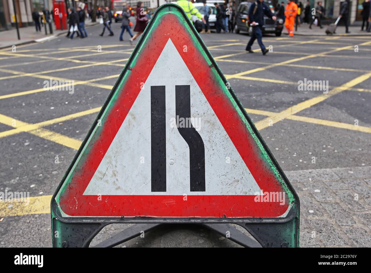 Road Narrows Traffic Sign at City Street Intersection Stock Photo - Alamy