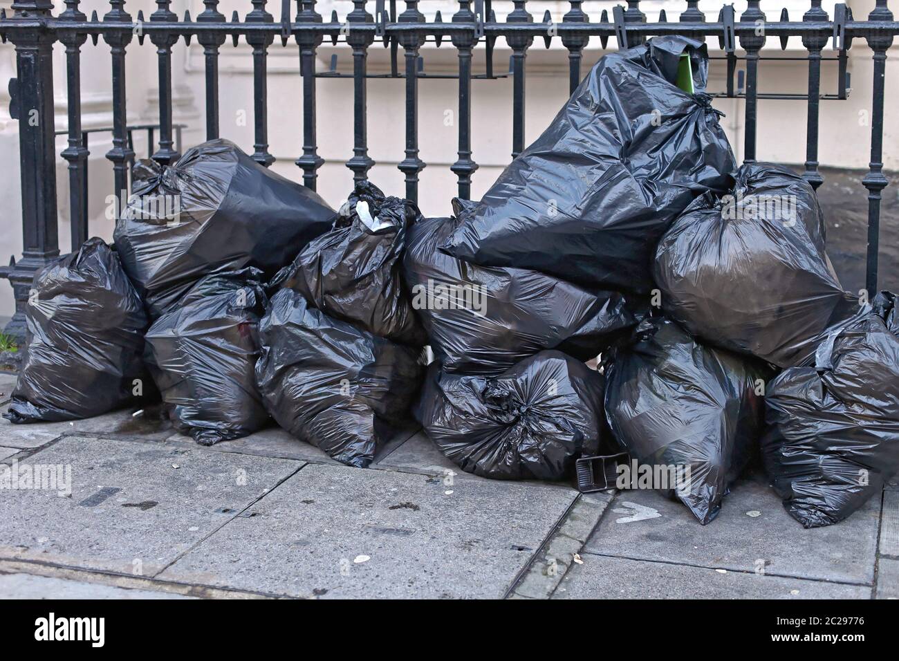 Bunch of Trash in Big Black Bags at Street Stock Photo - Alamy