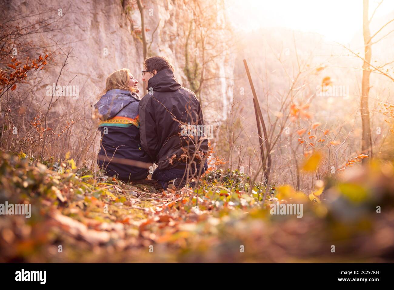 Loving couple enjoys the mountain view, beautiful scenery with sundown ...
