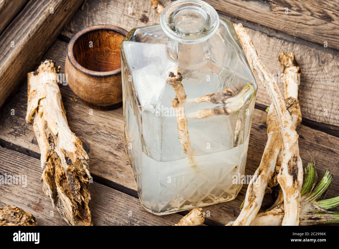 Preparation of alcohol tincture from fresh horseradish root Stock Photo ...