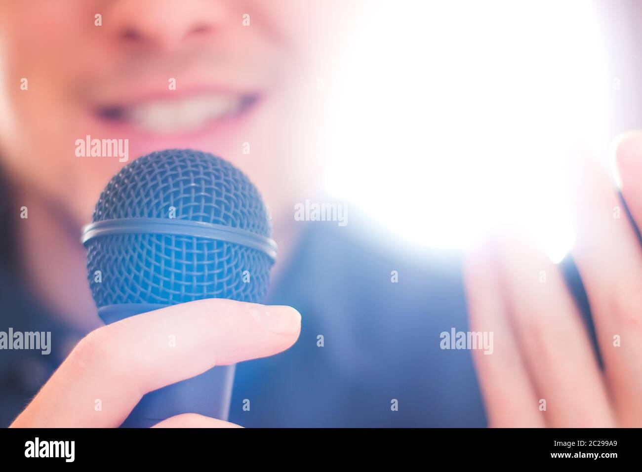 Press officer is speaking into a microphone and giving an interview ...