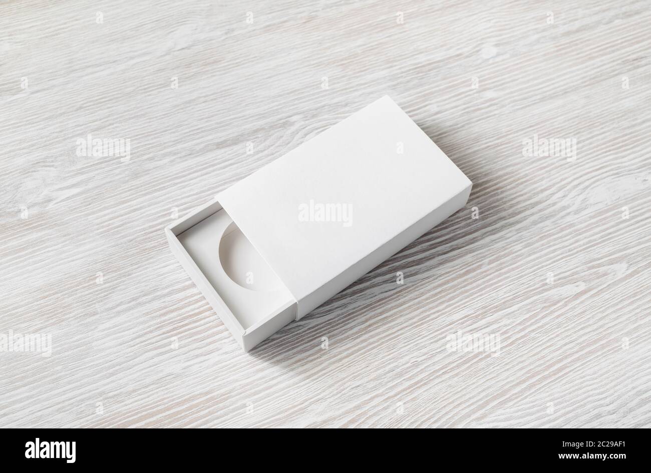 Blank opened box on light wood table background. Responsive design ...
