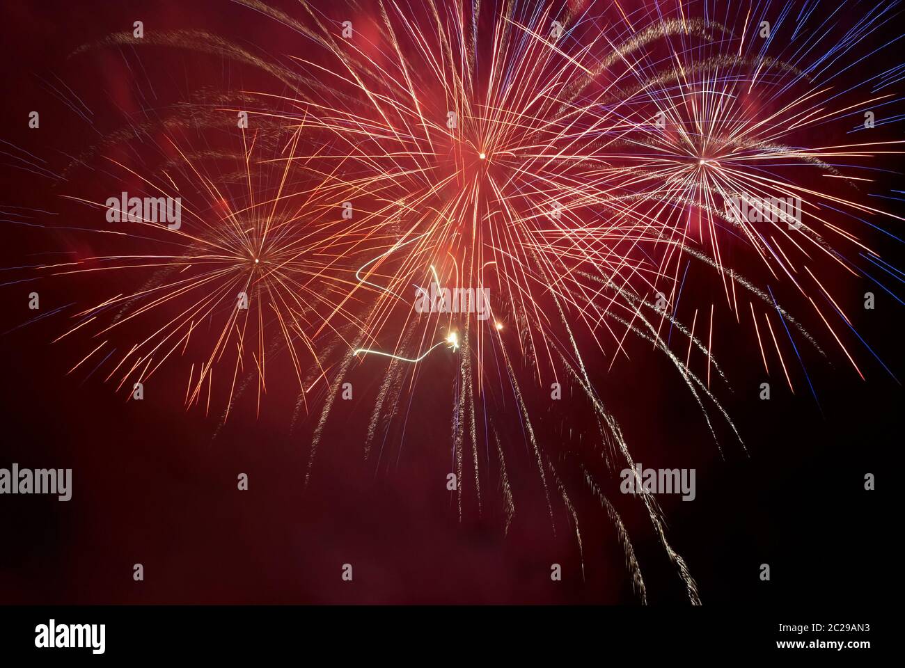 Red colorful fireworks on the black sky background. Holiday celebration ...