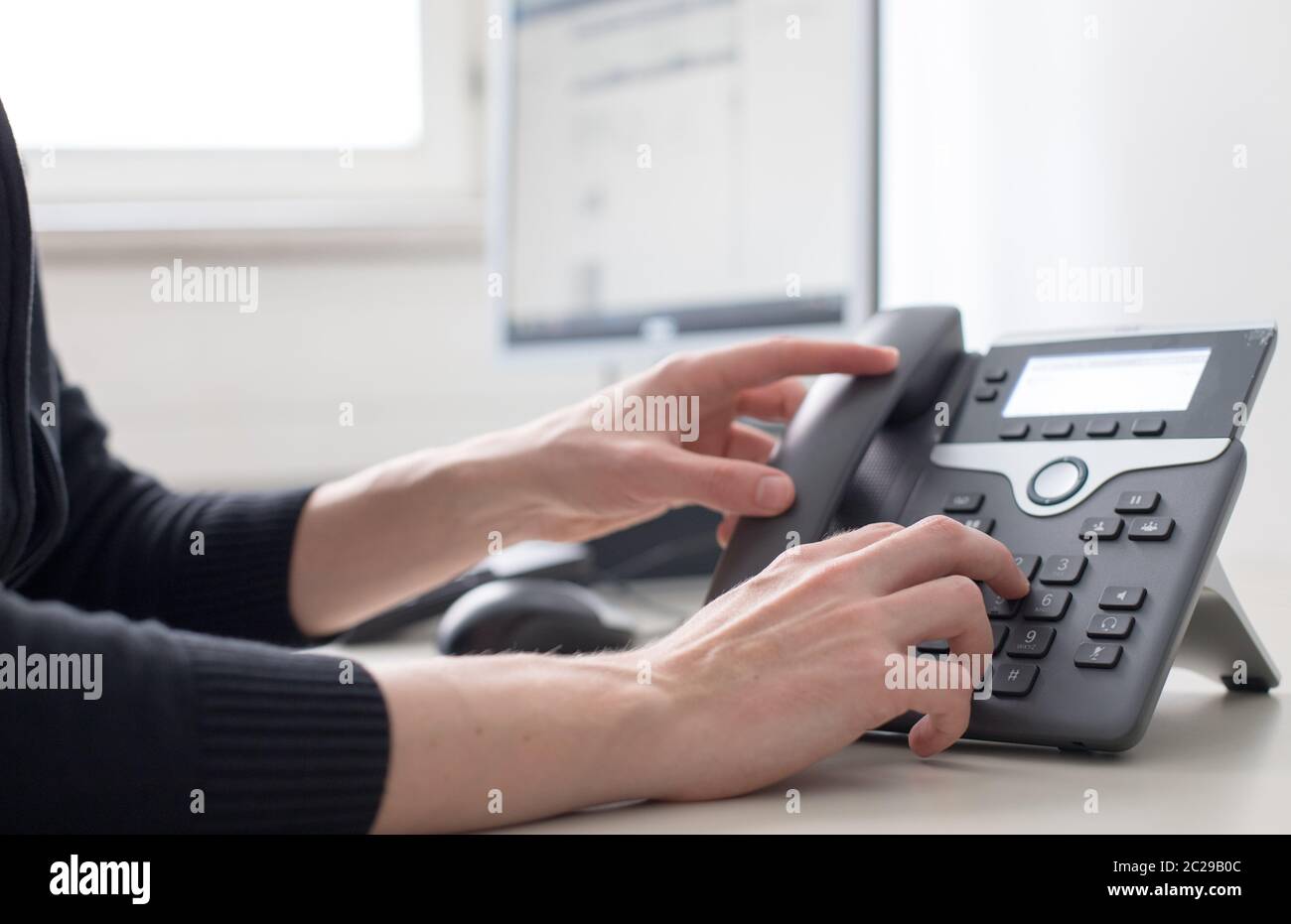 Office black telephone hand hi-res stock photography and images - Alamy