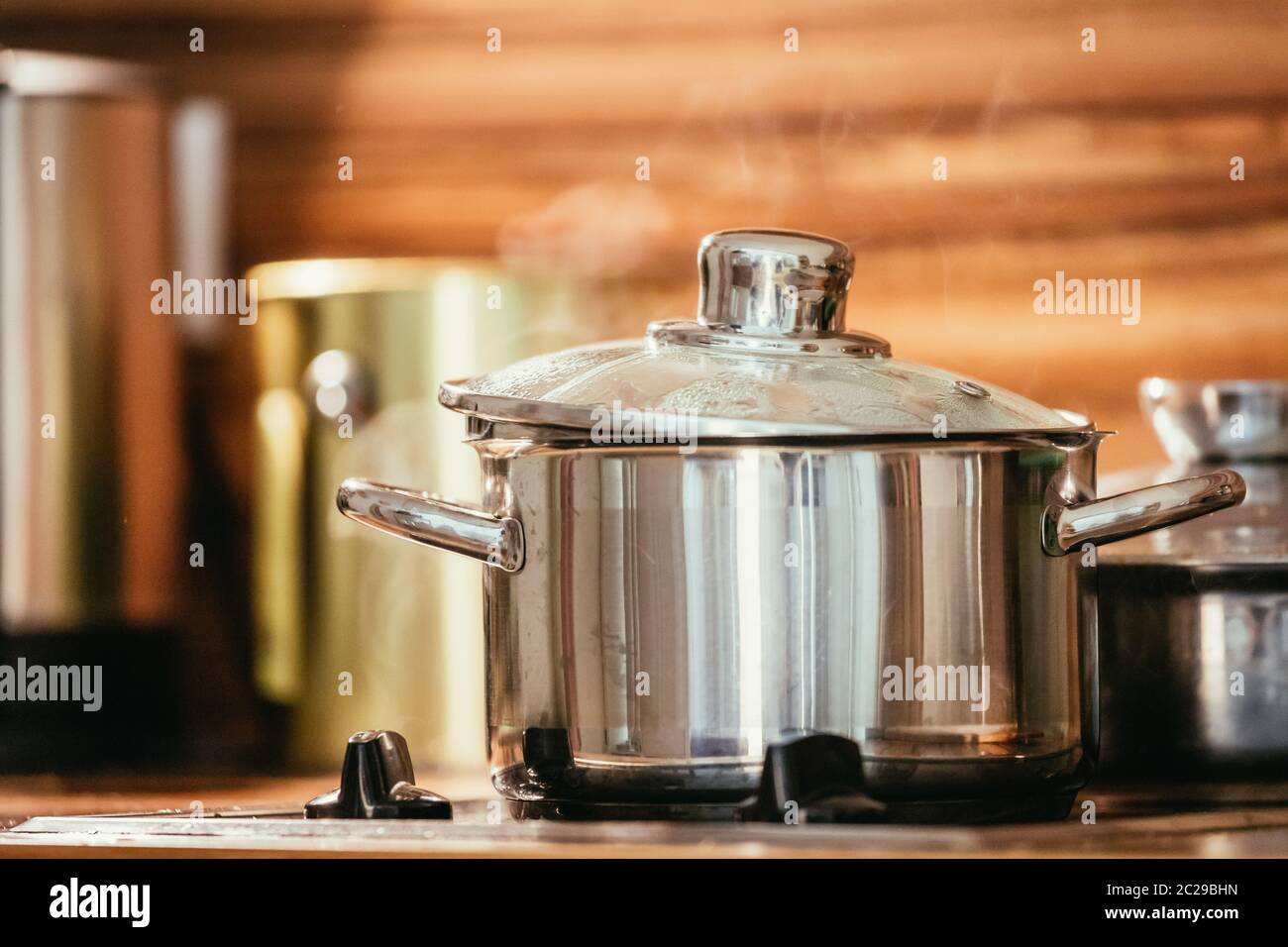 Steaming metal pot in the kitchen, wood Stock Photo - Alamy
