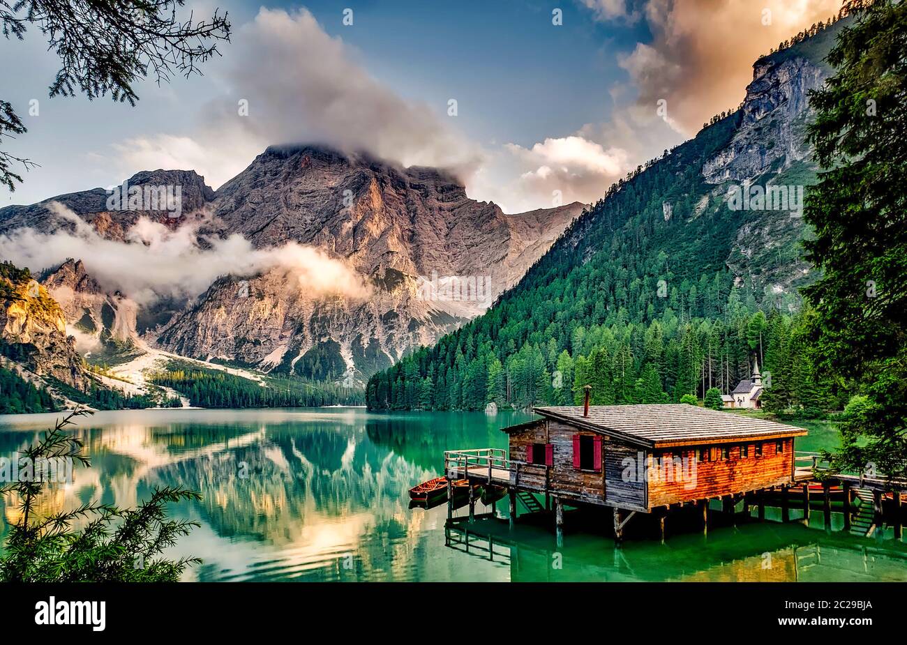 Italian Lake, Boathouse and Church, with Mountains in background Stock ...
